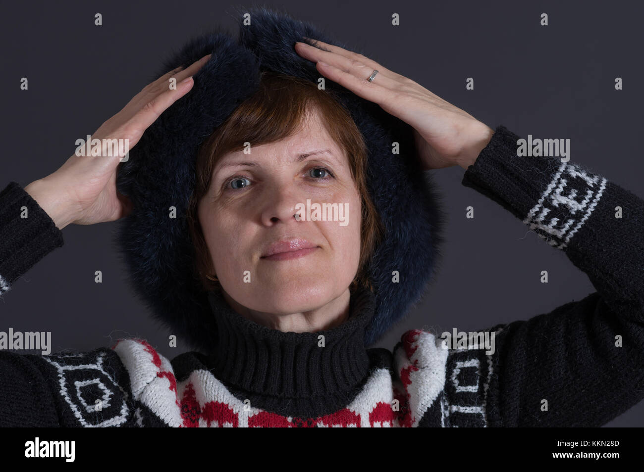 Indoor Portrait Of Caucasian Senior Woman In Winter Garments Being