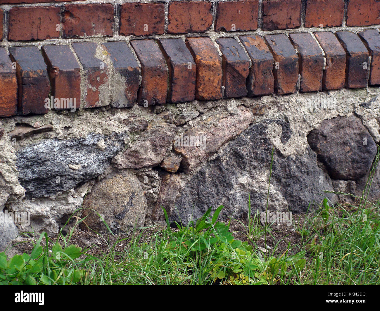 Retro stone foundation of red brick house close up Stock Photo - Alamy