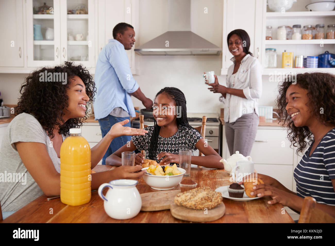 Family With Teenage Children Eating Breakfast In Kitchen Stock Photo ...