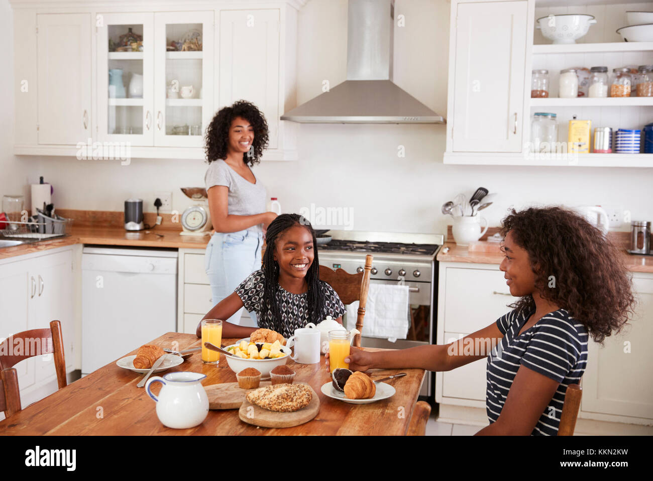 Three Teenage Girls Eating Breakfast In Kitchen Together Stock Photo ...