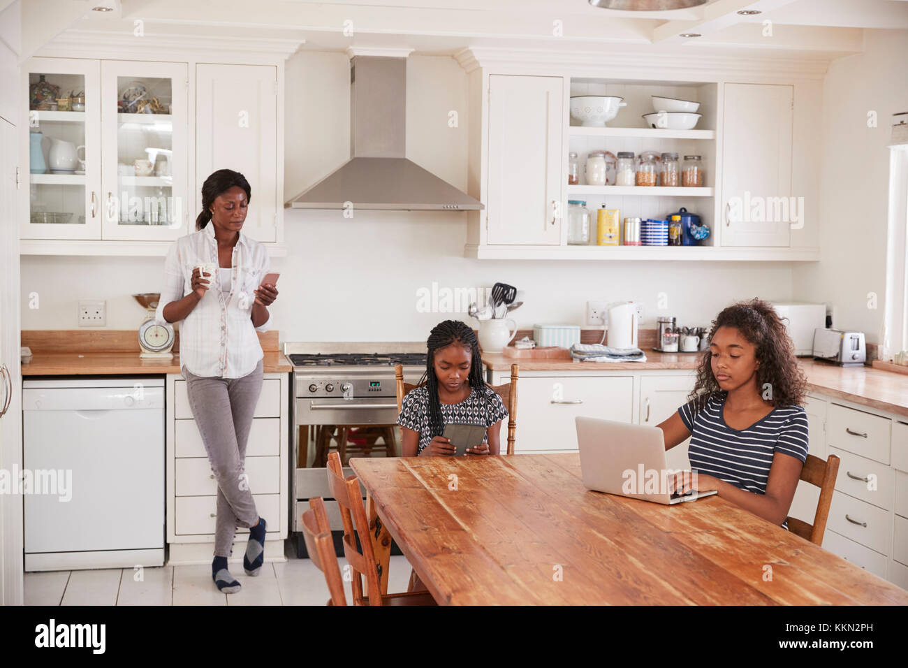 African american daughter doing homework table hi-res stock photography ...