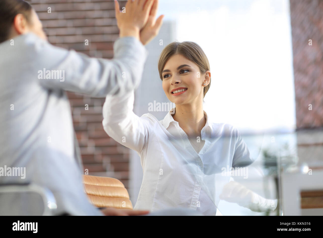 members of the business team giving each other a high five Stock Photo ...