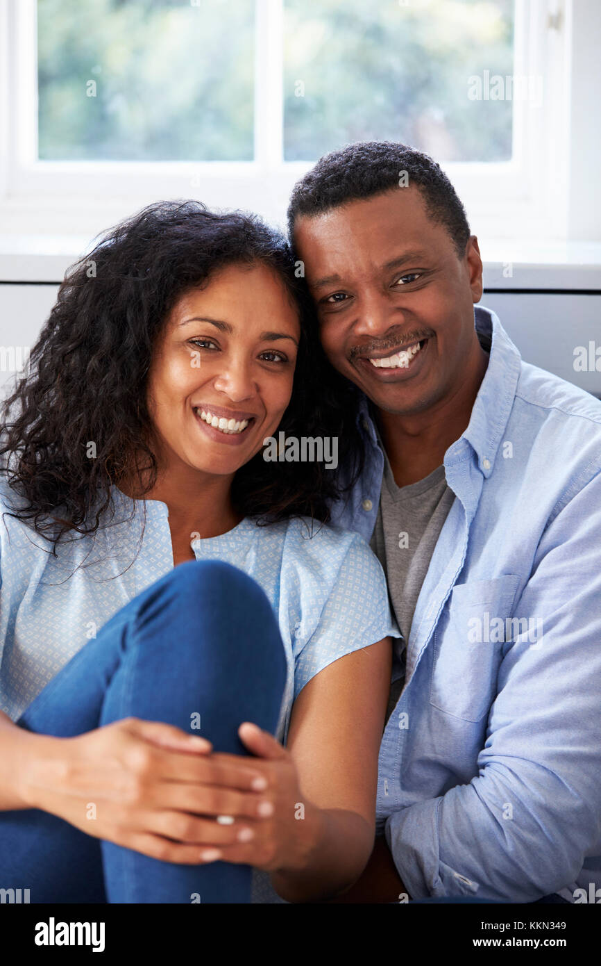 Portrait Of Romantic Couple Relaxing In Chair At Home Stock Photo - Alamy