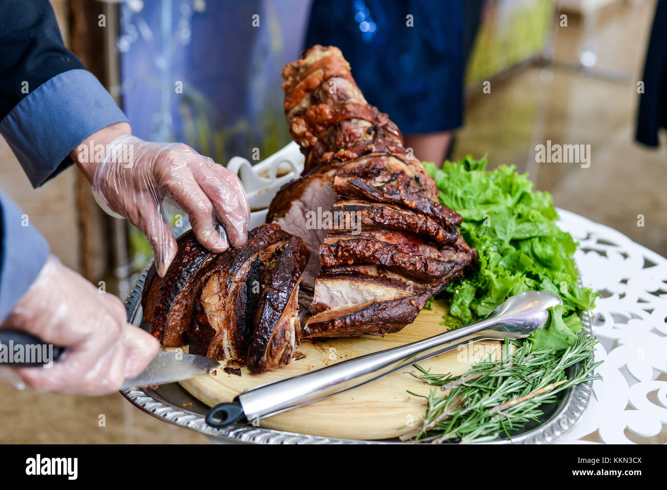 Pork knuckle in the hands of the chef cook. Hot dish on the kitchen ...