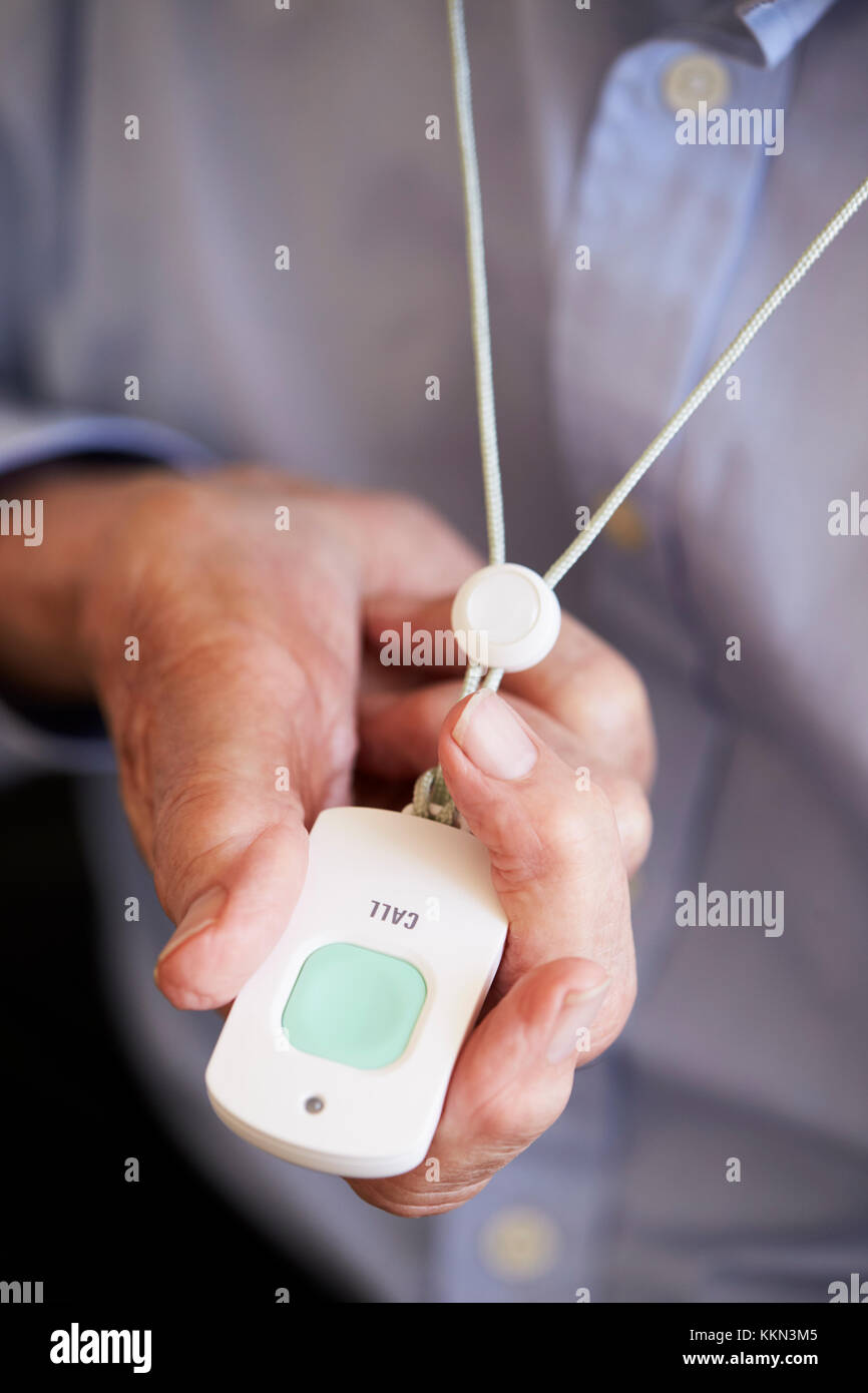Senior Man At Home Using Distress Alarm Call Button Stock Photo - Alamy