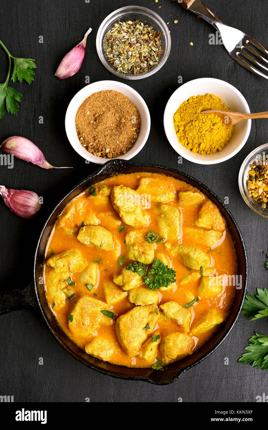 Delicious chicken curry on dark stone background. Top view, flat lay ...