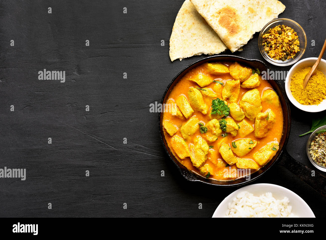 Indian chicken curry on black stone background with copy space. Top ...