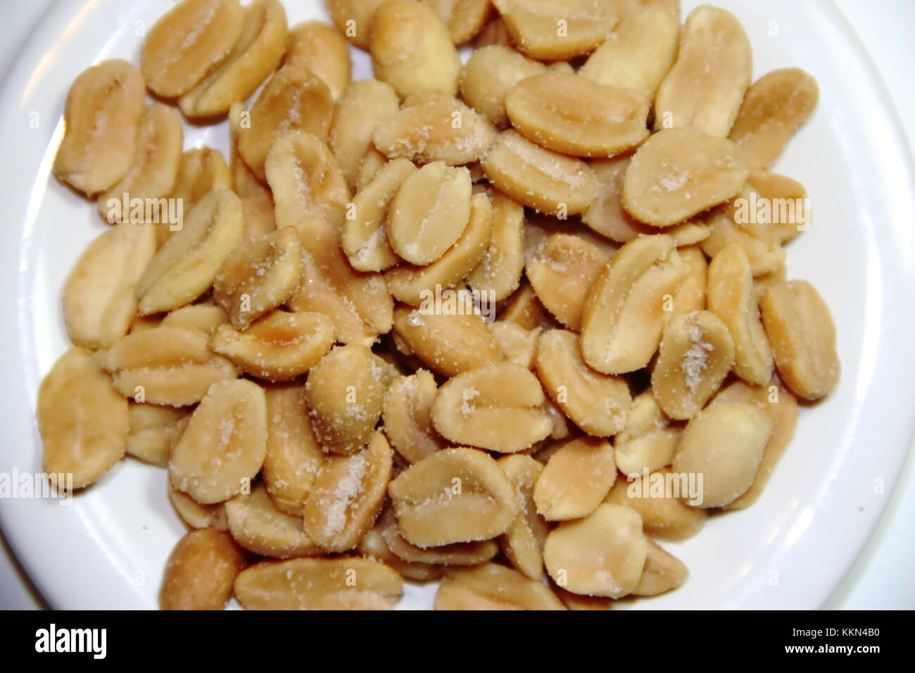 variety of salty peanuts with and without peel on white background ...