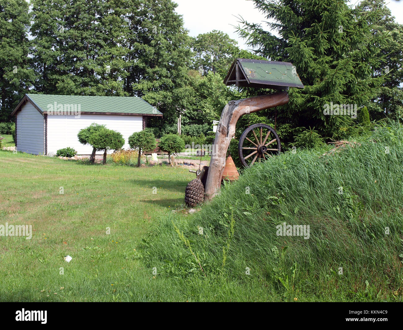 Recreation place in garden with trees bushes and homemade wooden decor ...