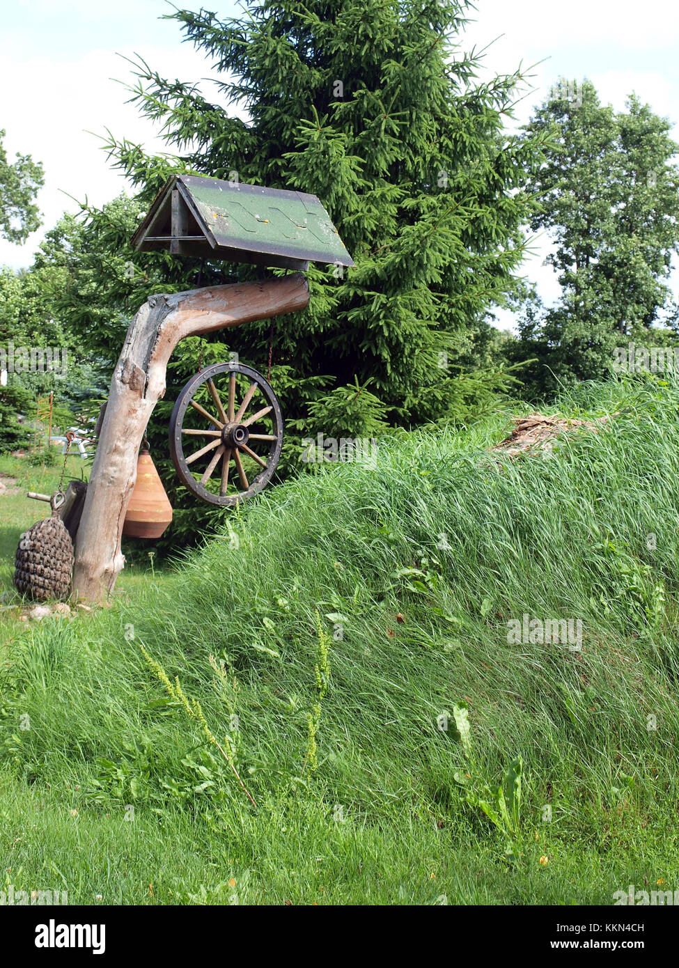 Recreation place in garden with trees bushes and homemade wooden decor ...