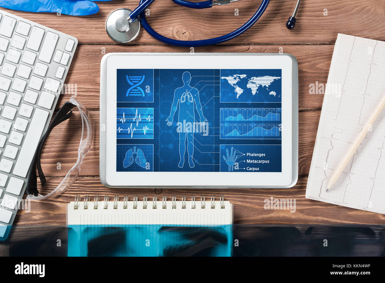 White tablet pc and doctor tools on wooden table Stock Photo - Alamy