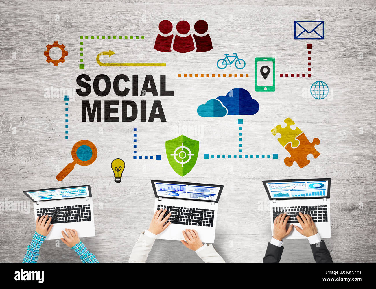 Group of three people with devices in hands working together as symbol ...