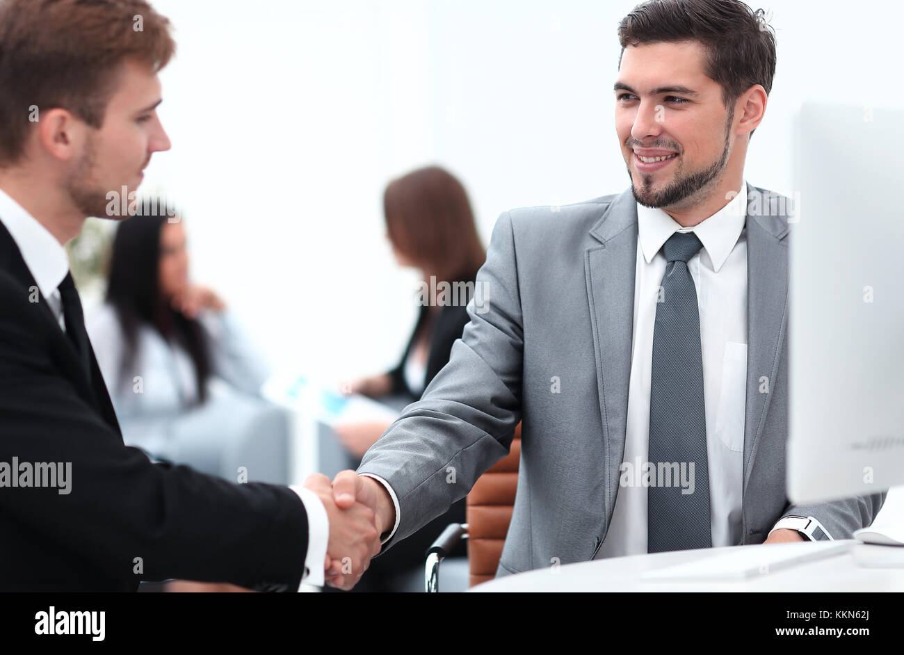 handshake Manager and the client in the office Stock Photo - Alamy