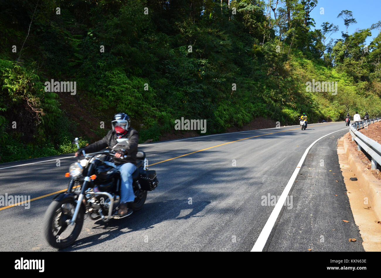 Thai people and foreigner traveler riding motorcycle on the road in Sri ...