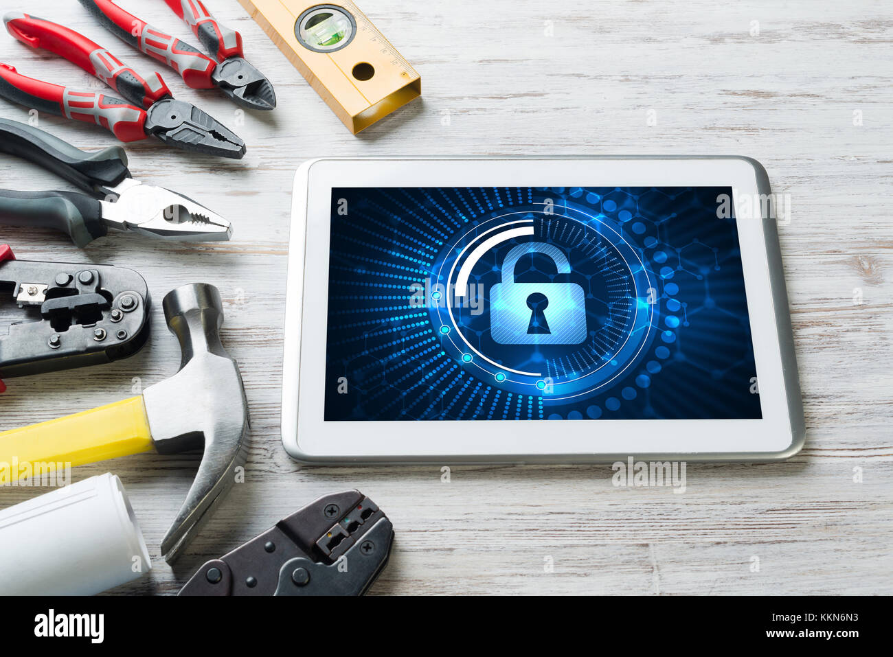 Tablet pc with security concept on screen and industrial tools around ...