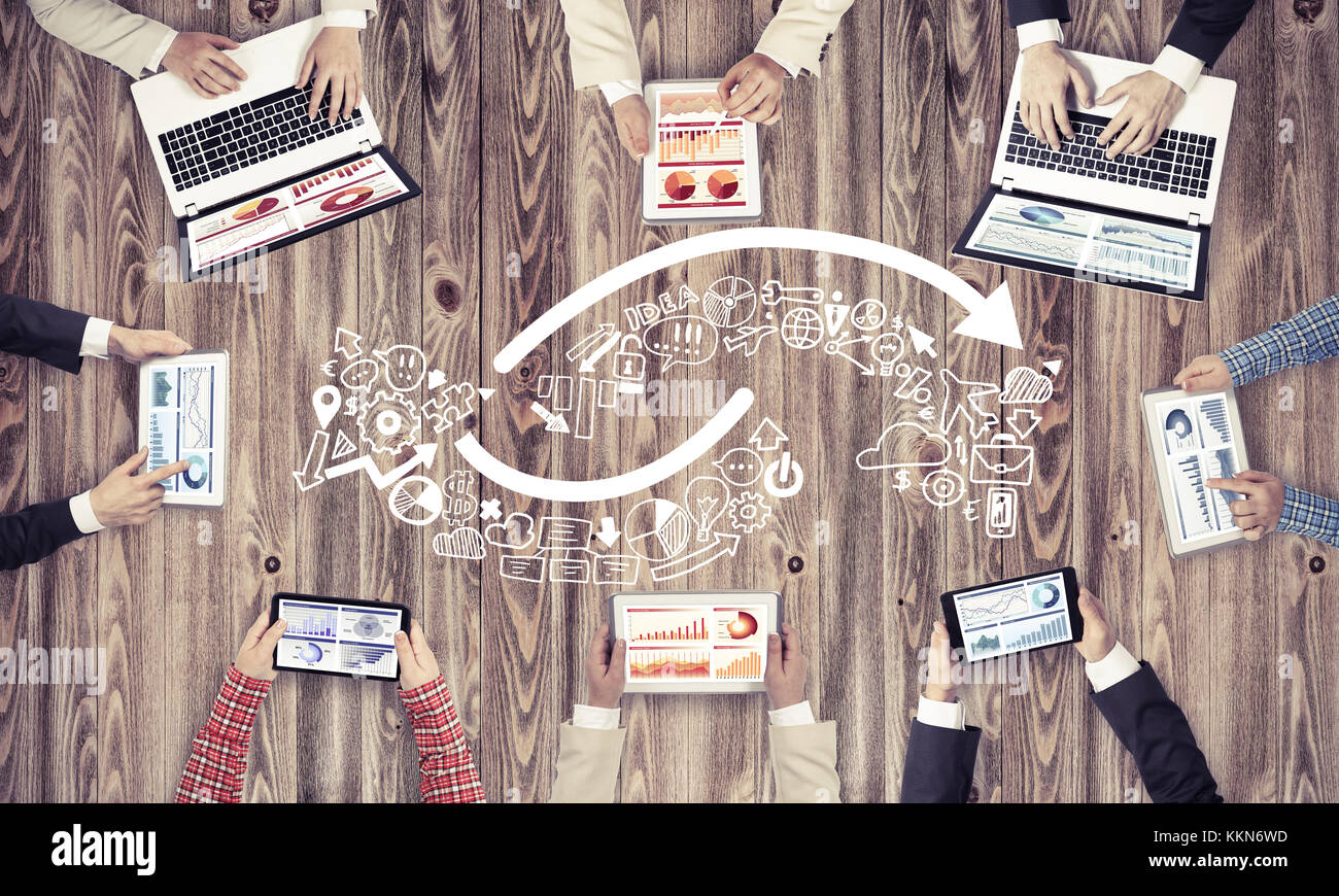 Group of people with devices in hands working together as symbol of ...