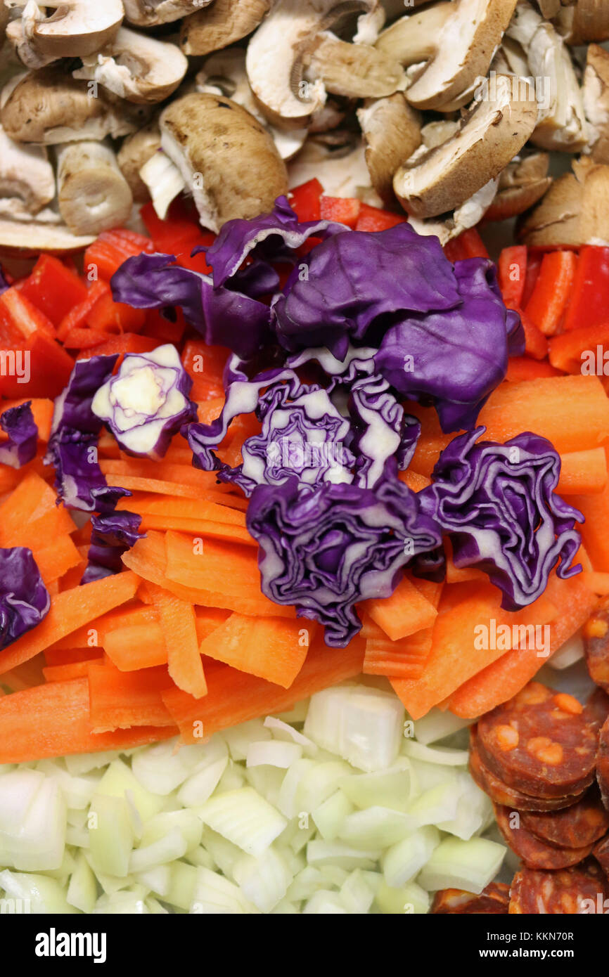 Chopped ingredients for stir fry on a white plastic board. Food ...