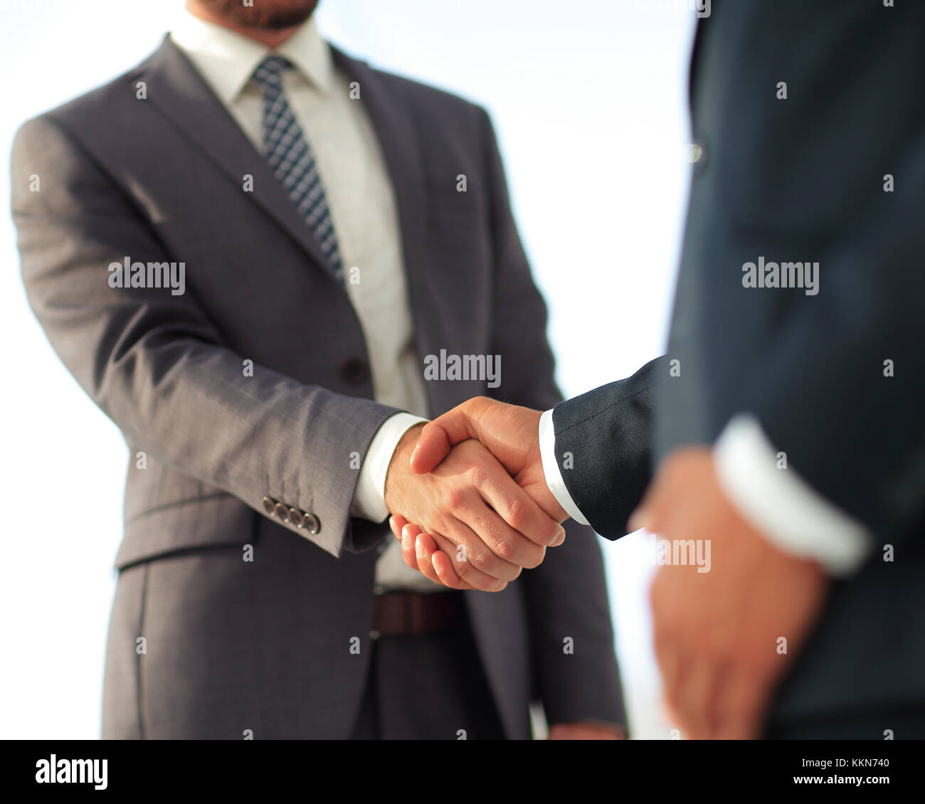 Friendly smiling businessmen handshaking. Business concept photo Stock ...
