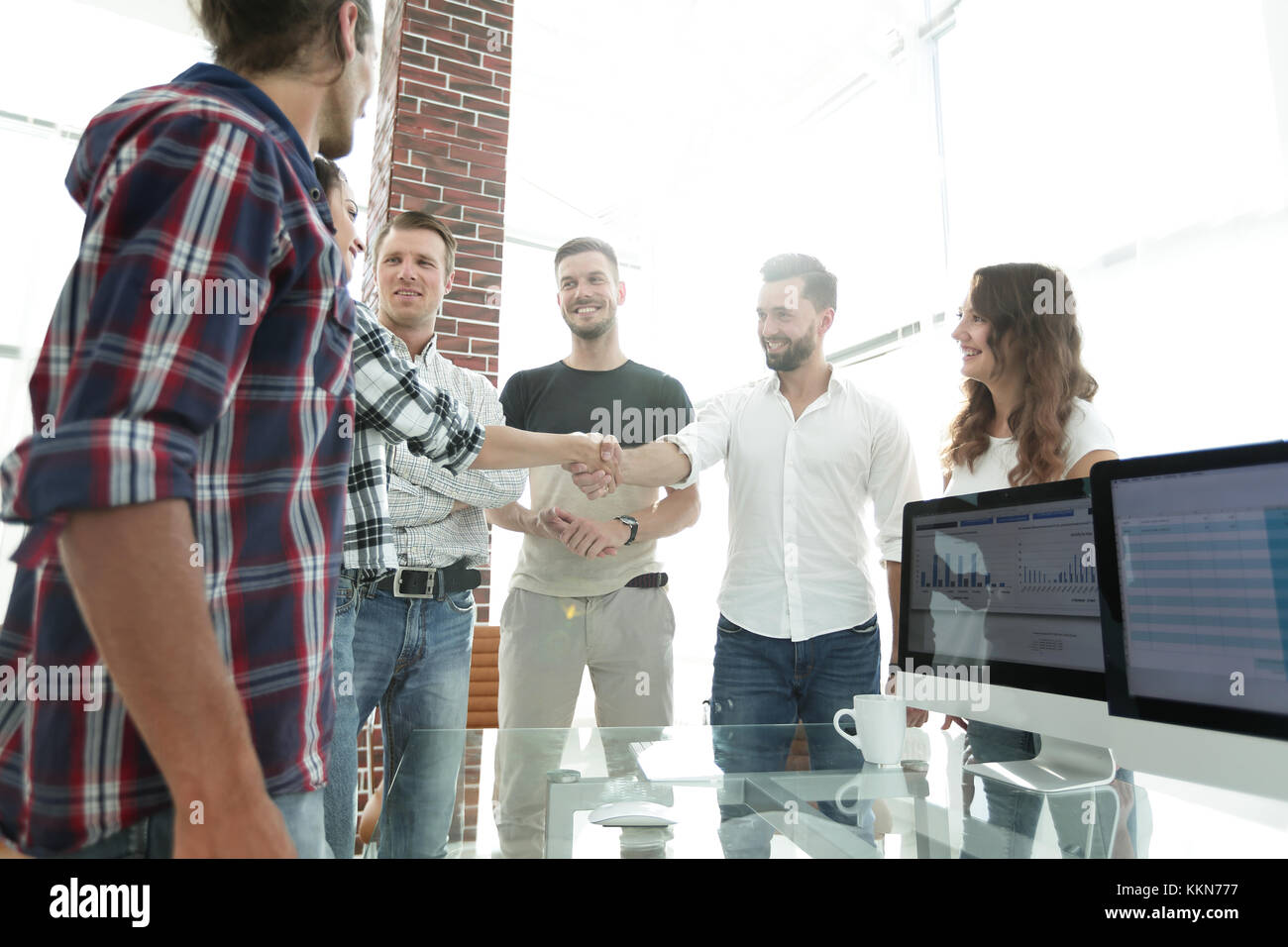handshake partners in the creative office Stock Photo - Alamy
