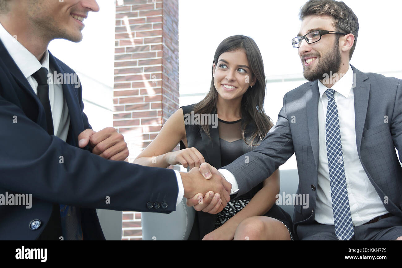 handshake Manager and the client at a meeting in the office lobby Stock ...