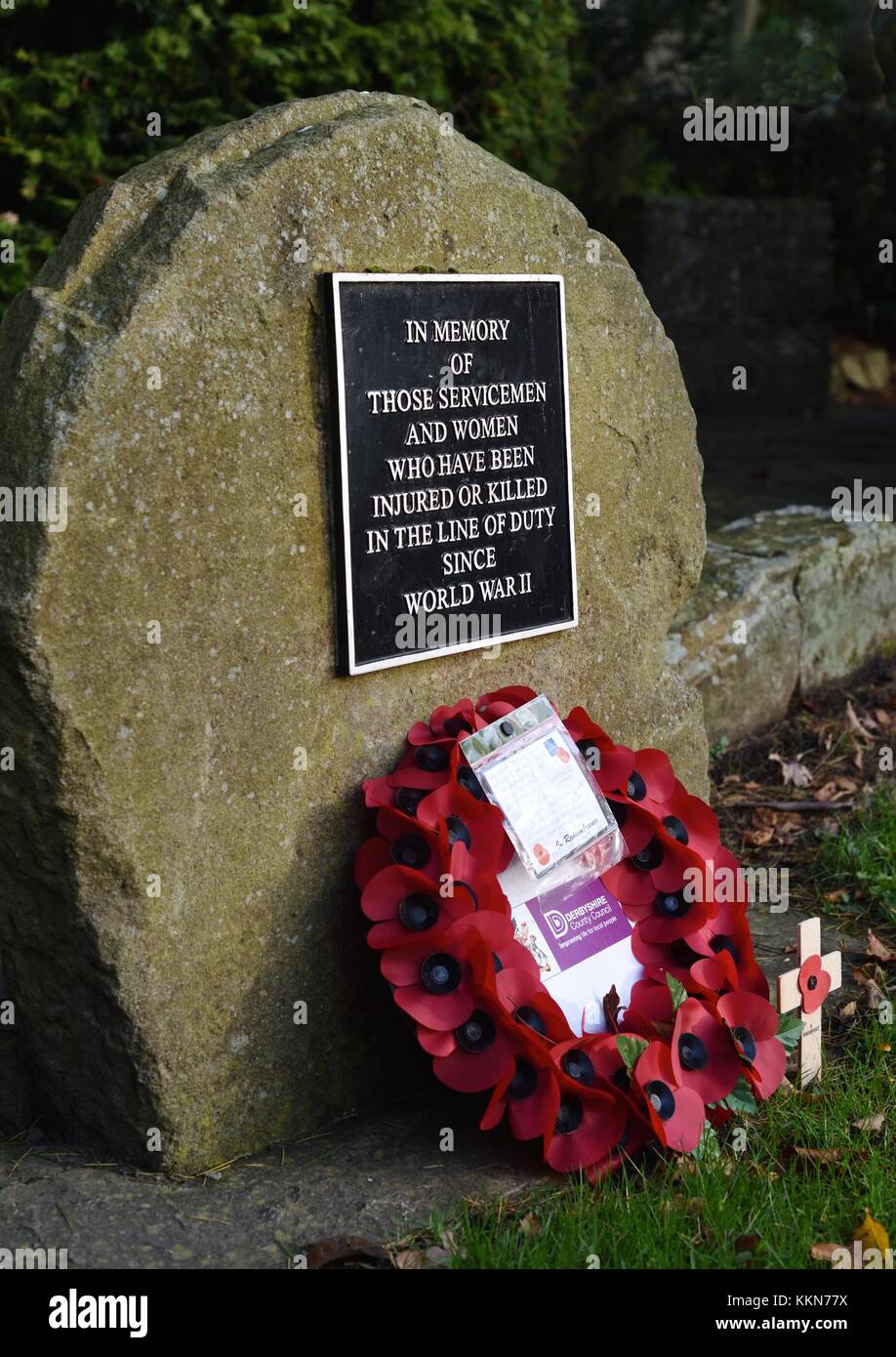 a wreath placed on a memorial stone in High Lea Park, New Mills ...