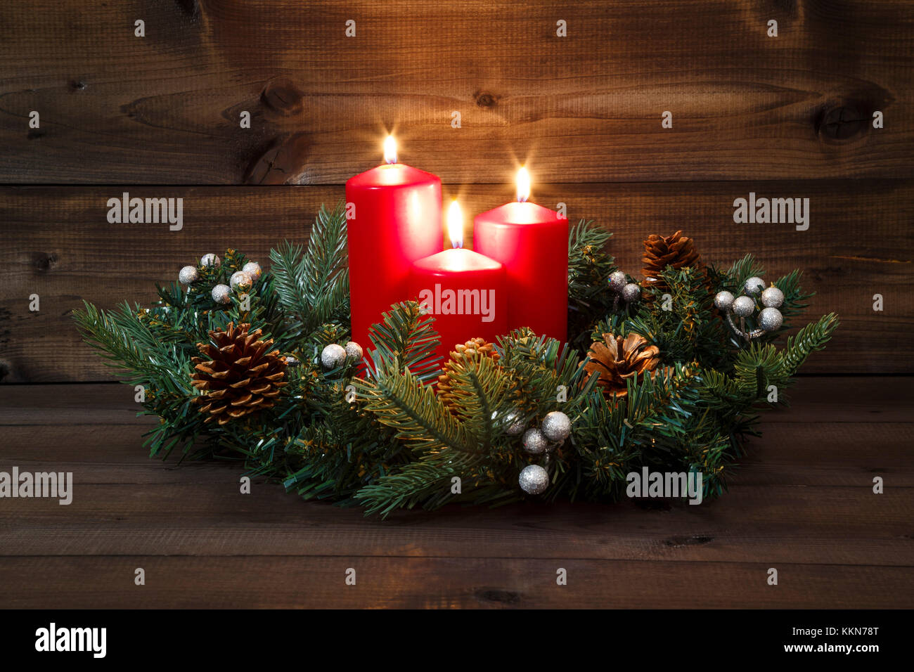 Third Advent - Decorated Advent wreath with three red burning candles ...