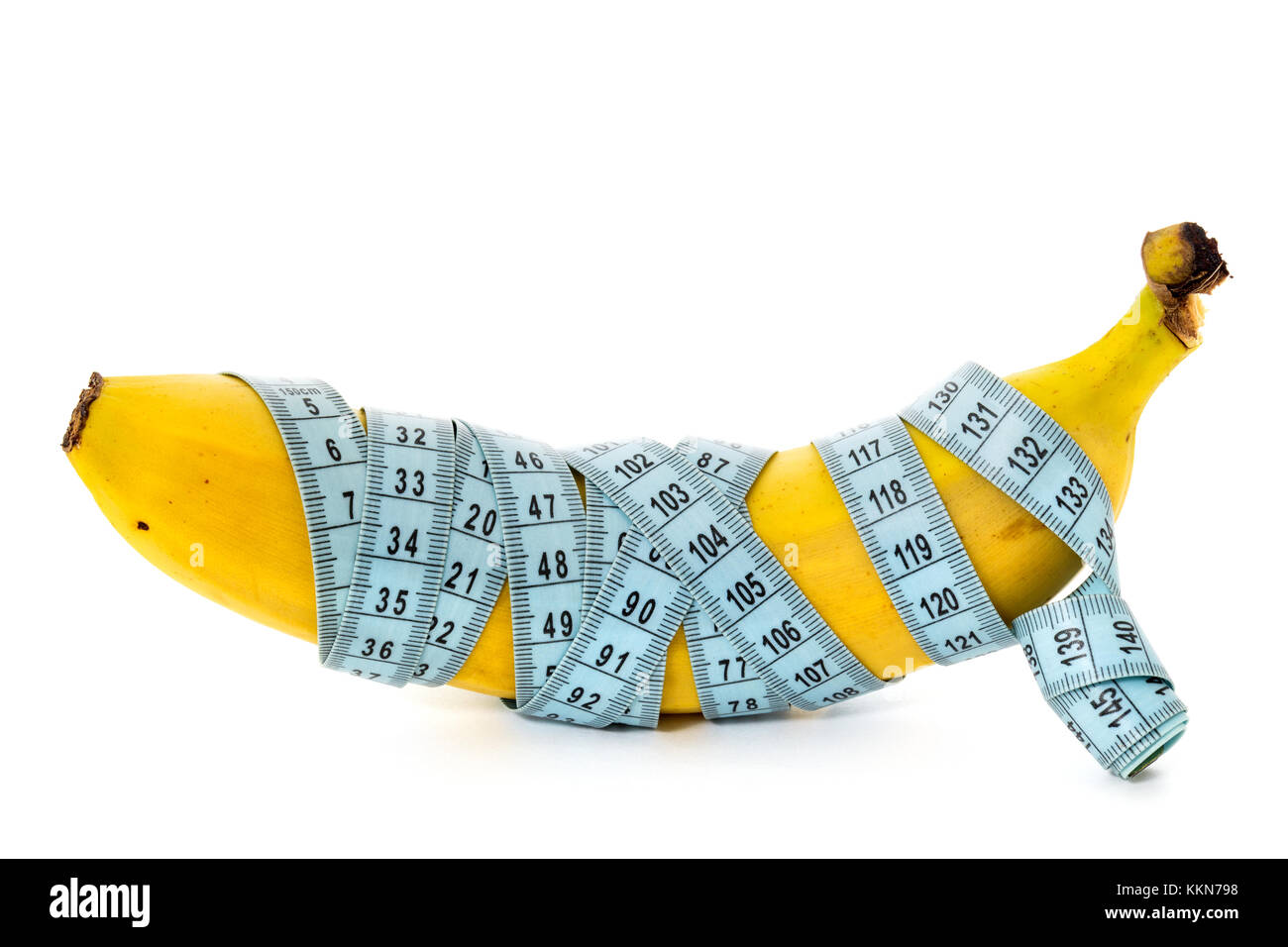 Banana and measuring tape on the white background. Healthy dieting ...