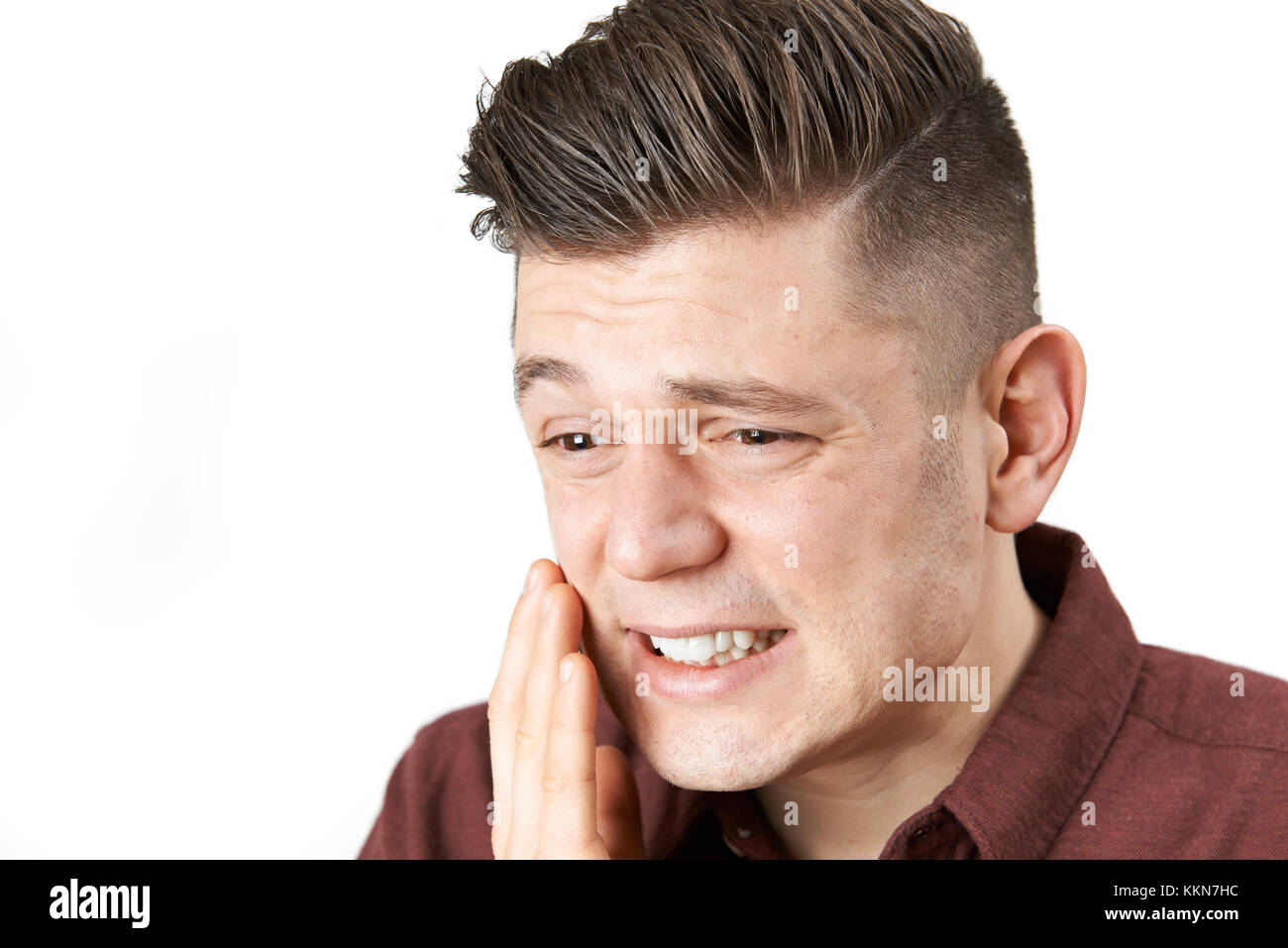 Studio Shot Of Young Man Suffering With Toothache Stock Photo - Alamy