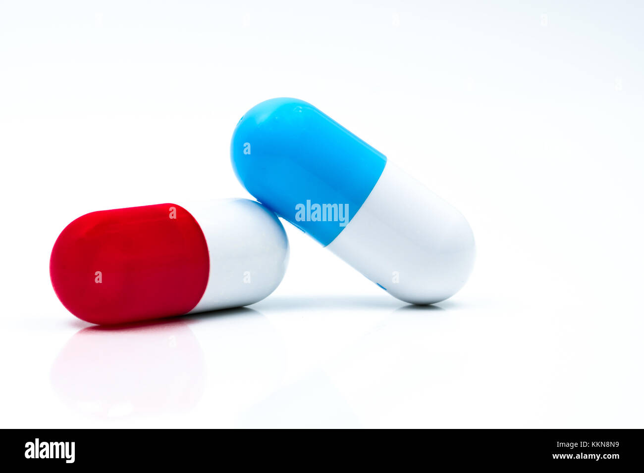 Two capsule pills isolated on white background. Global healthcare ...