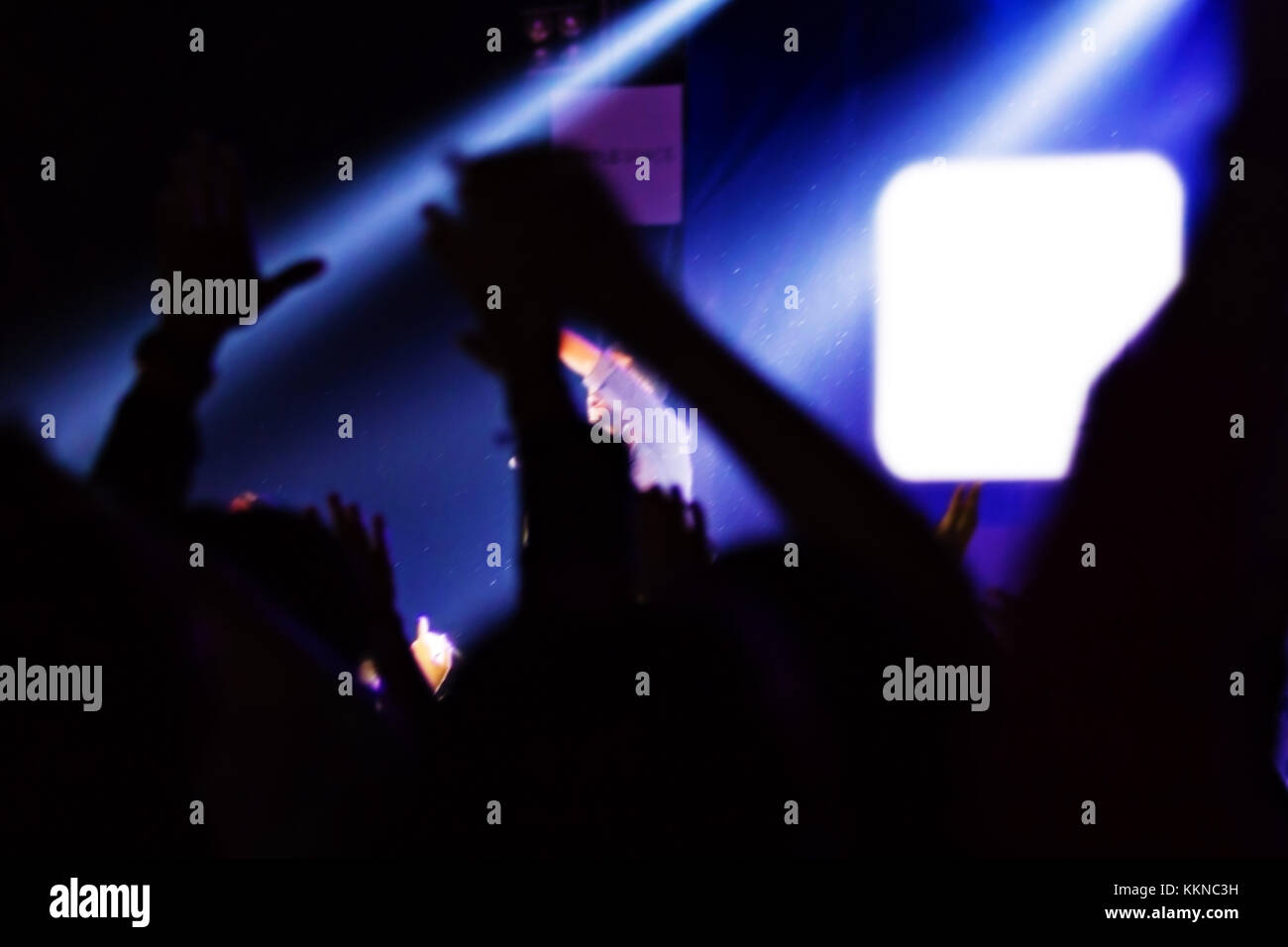 Blurred image of audience raising hands up in music festival.Crowd at ...