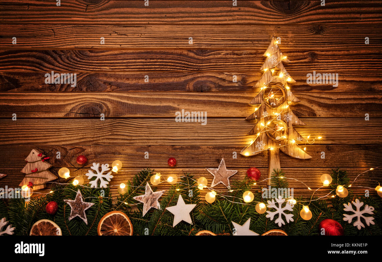 Christmas background with wooden decorations, tree and spot lights ...