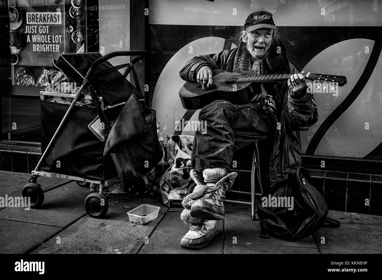 Homeless Man Busking in The Street With Belongings In Manchester City ...