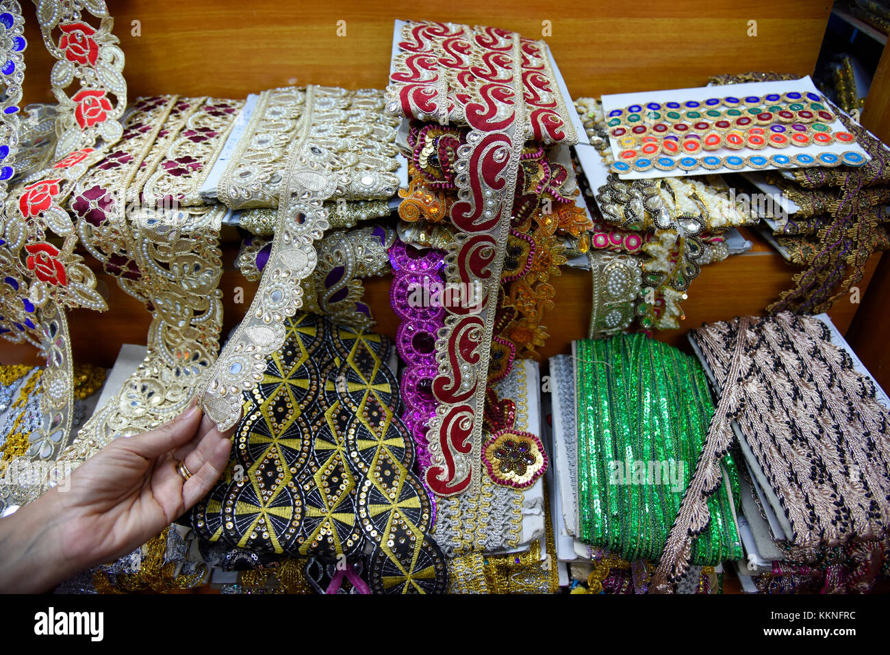 Oman Muscat Mutrah Souk A shop selling cloth and embroidered borders ...