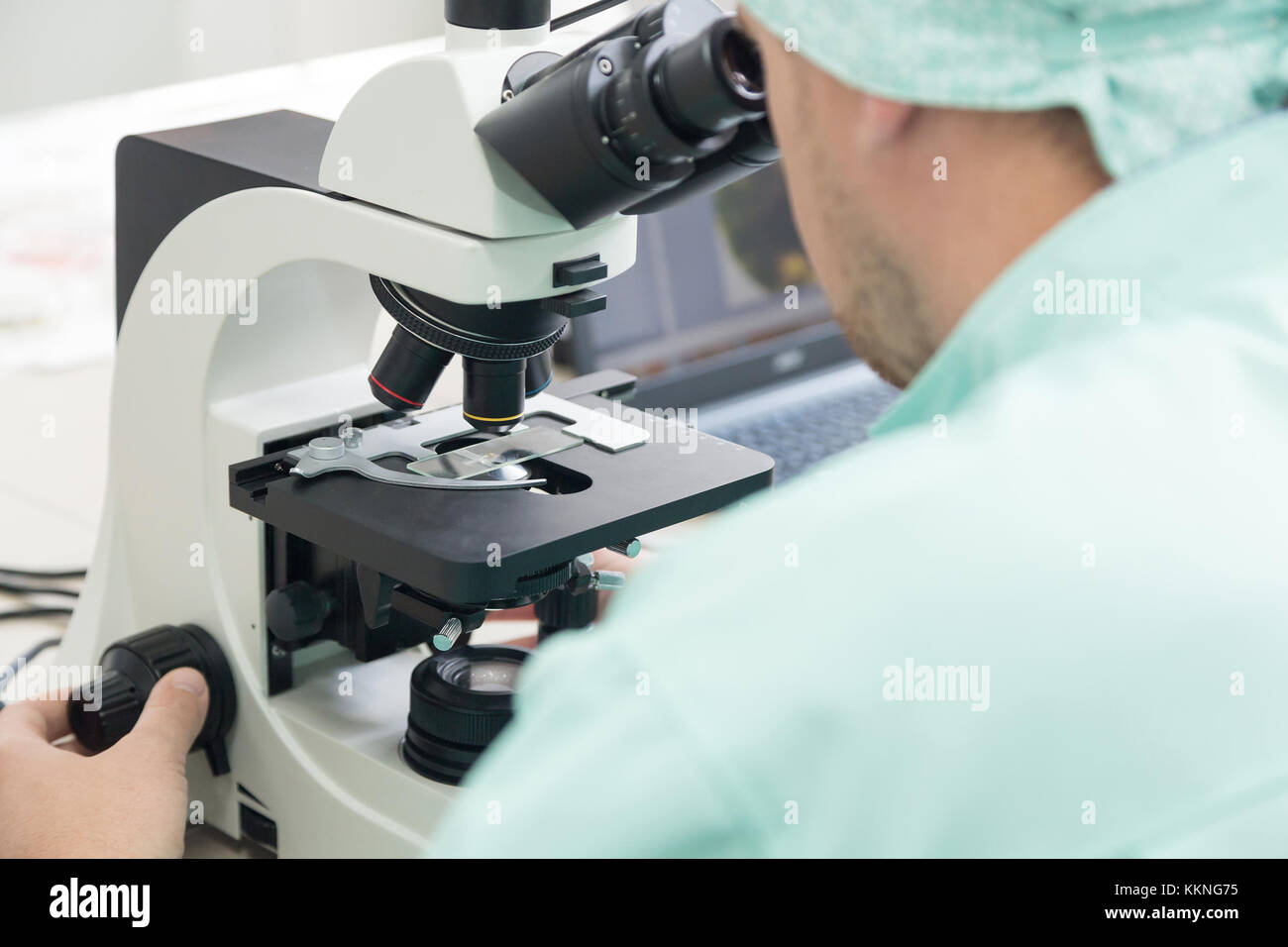 Close-up of a male scientific researcher using microscope in the ...
