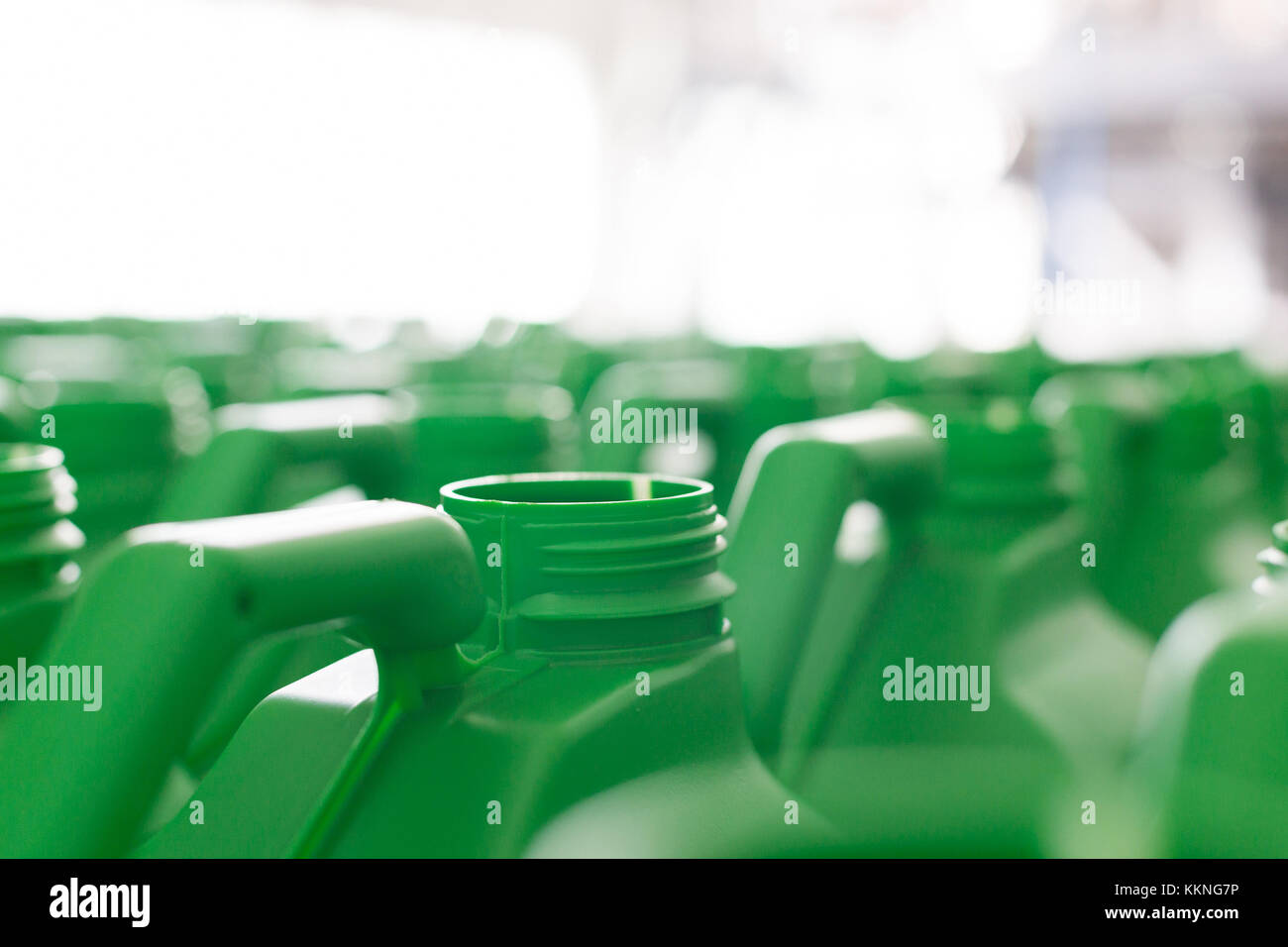 Empty plastic cans green colour for liquids. Concept: Manufacturing ...