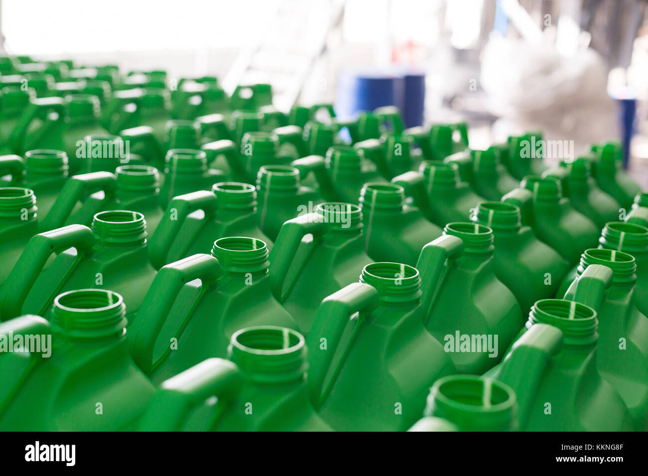 Empty plastic cans green color for liquids. Concept: Manufacturing ...