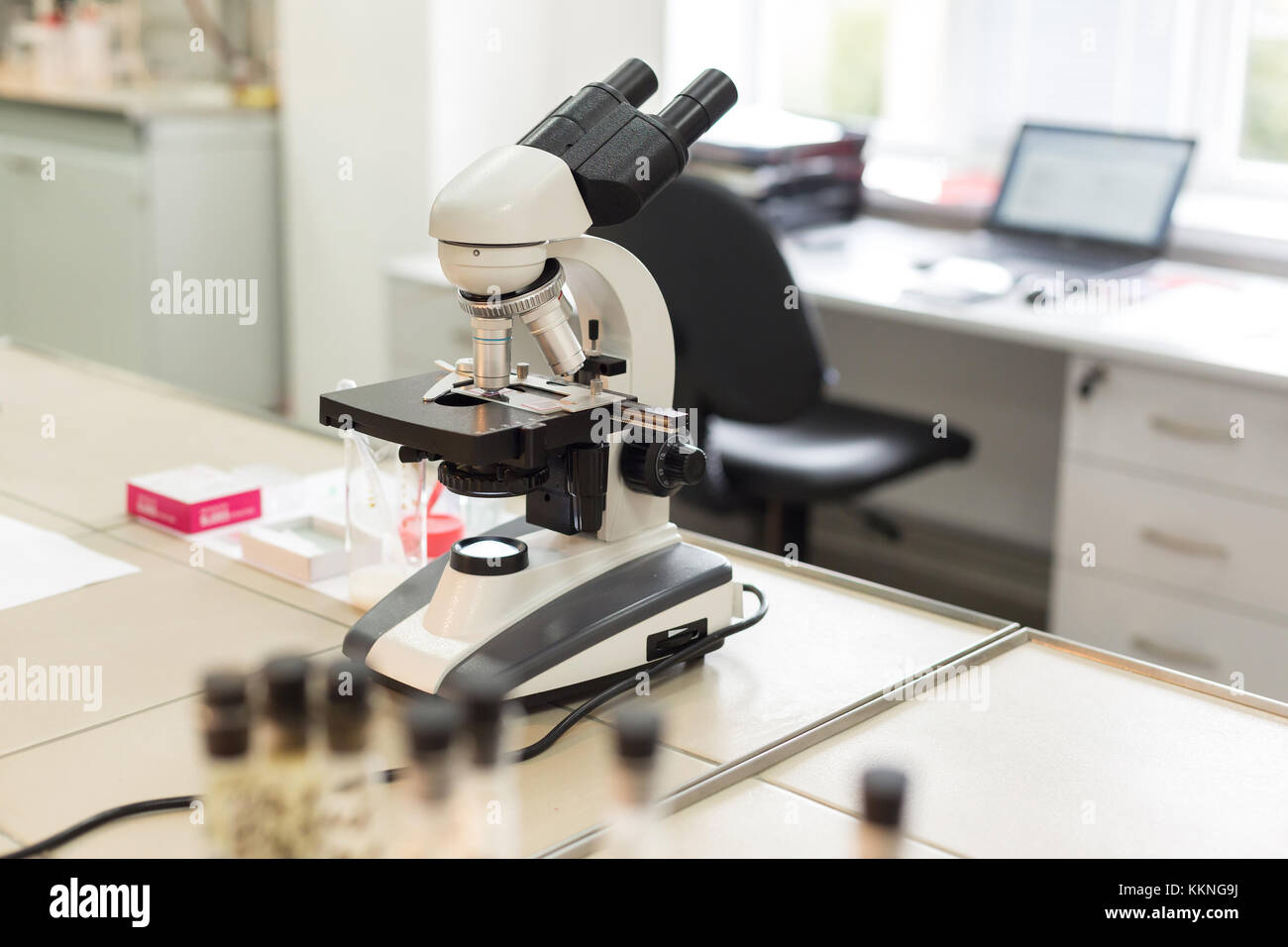Microscope in the laboratory on background table with computer. Concept ...