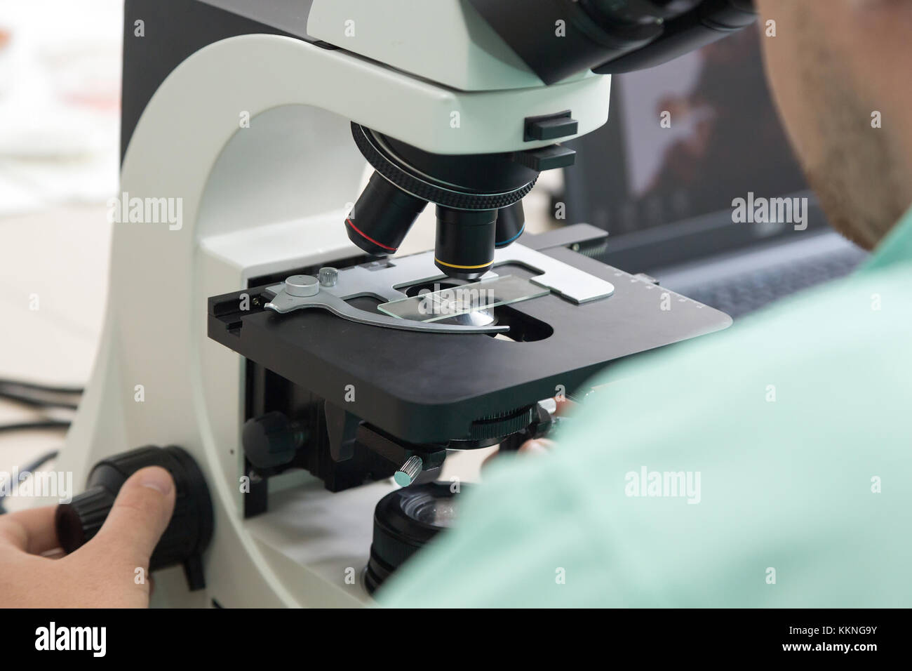 Close-up of a male scientific researcher using microscope in the ...