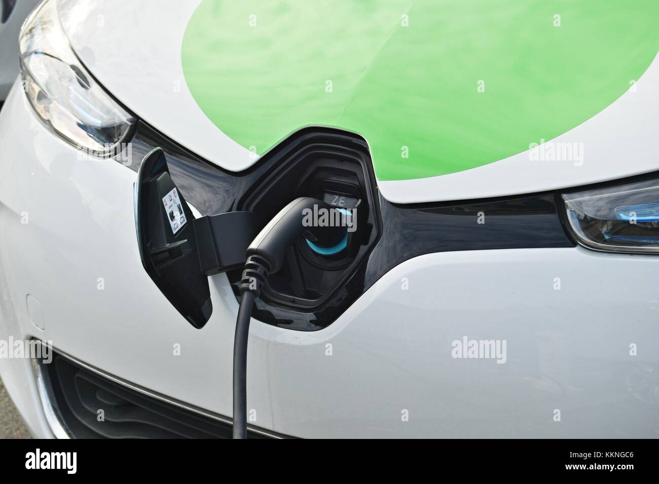 Close-up power supply connected to an electric car to add a charge to ...