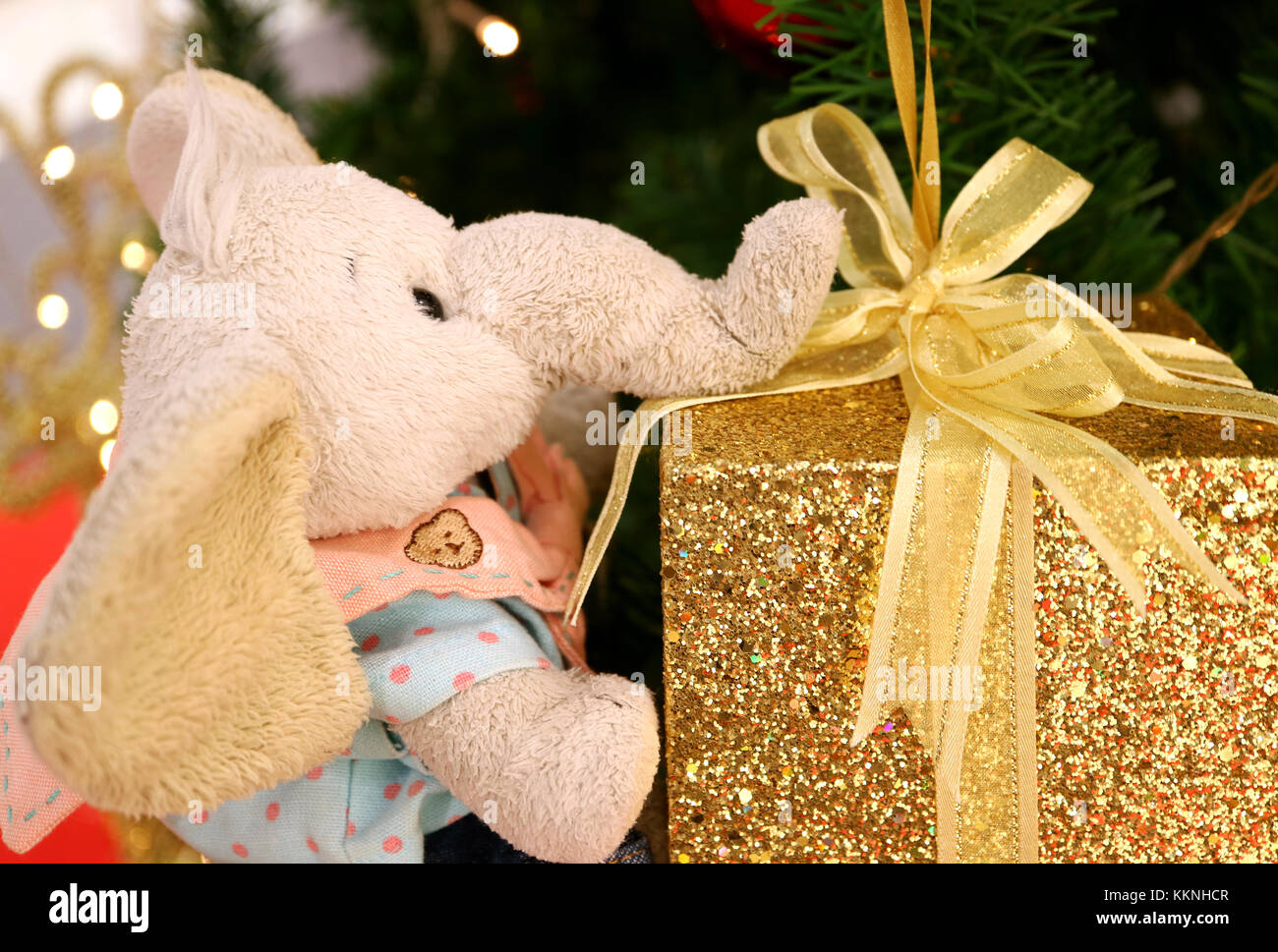Present for you! a cute elephant doll holding gold glitter gift box ...