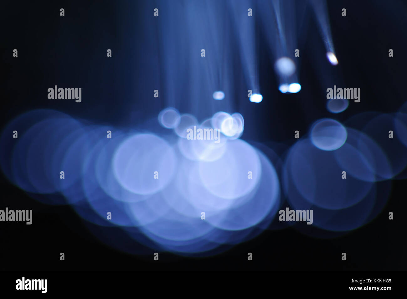 Abstract blue flashing lights on a dark background Stock Photo - Alamy