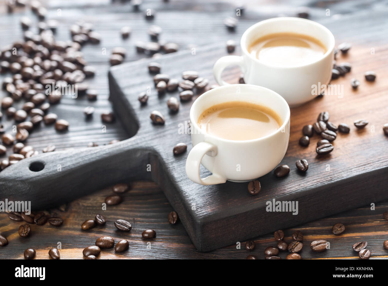 Two cups of coffee with coffee beans Stock Photo - Alamy