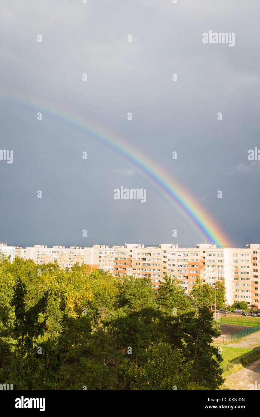 A bright rainbow over the city in the fall Stock Photo - Alamy