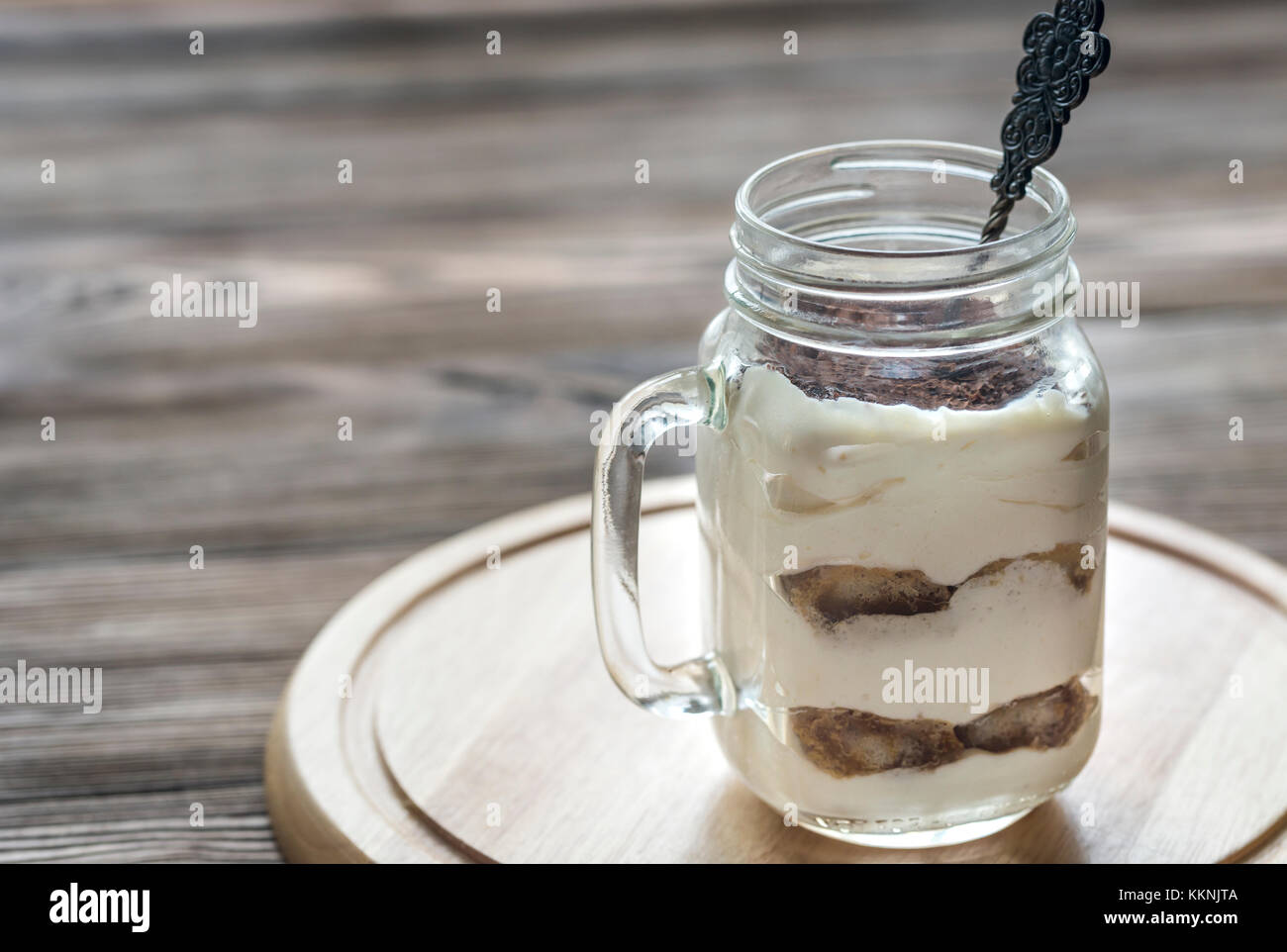 Tiramisu in the mason jaron the wooden background Stock Photo - Alamy