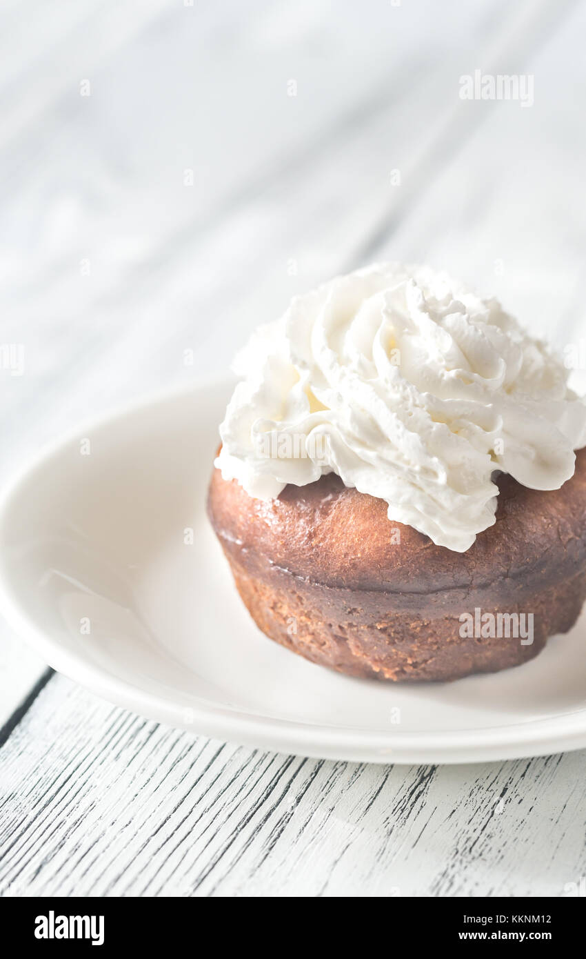 Rum baba decorated with whipped cream on the plate Stock Photo - Alamy