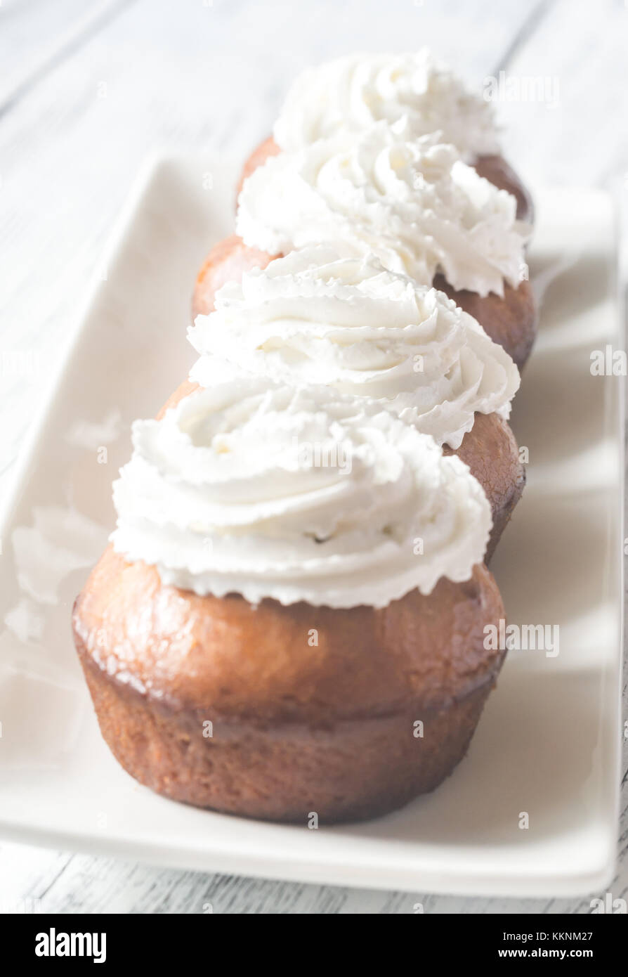 Rum baba on the plate arranged in a row Stock Photo - Alamy
