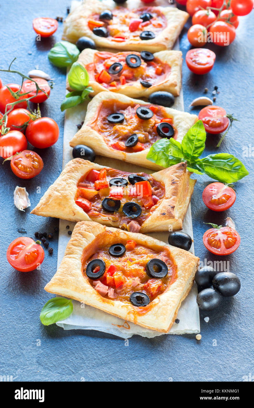 Mini pizza pastry,selective focus on front slice Stock Photo - Alamy