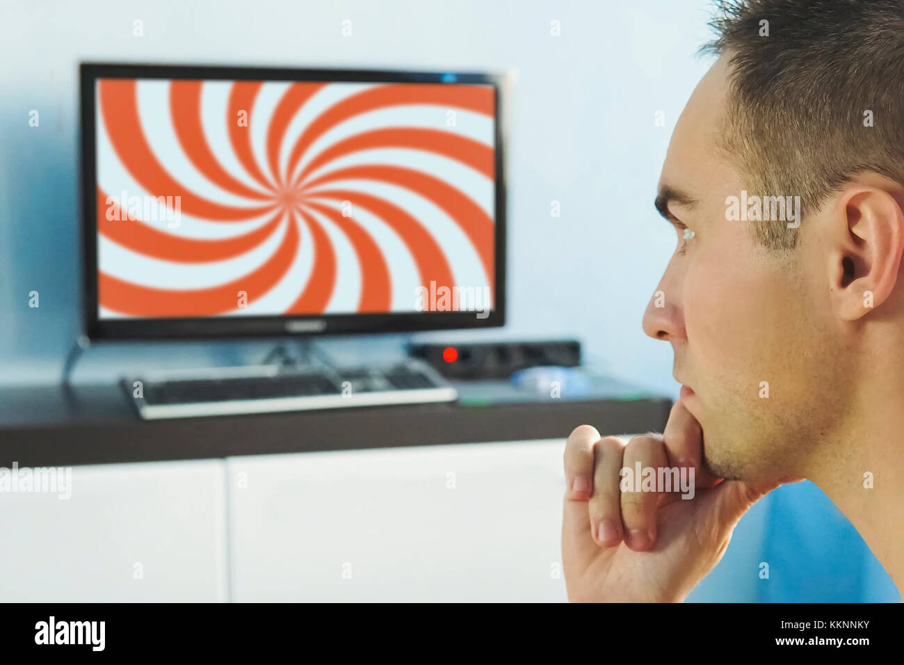 Brainwashed elderly man. hypnotic spiral on the screen of the TV. The ...