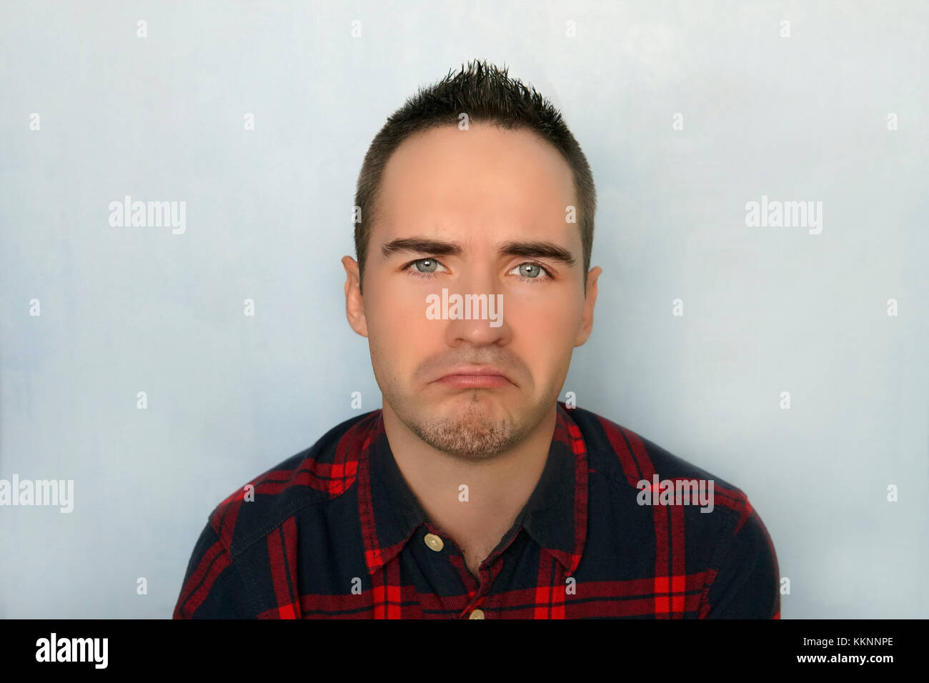 A young man with a sad expression. Frustrated guy. Portrait of a sad ...