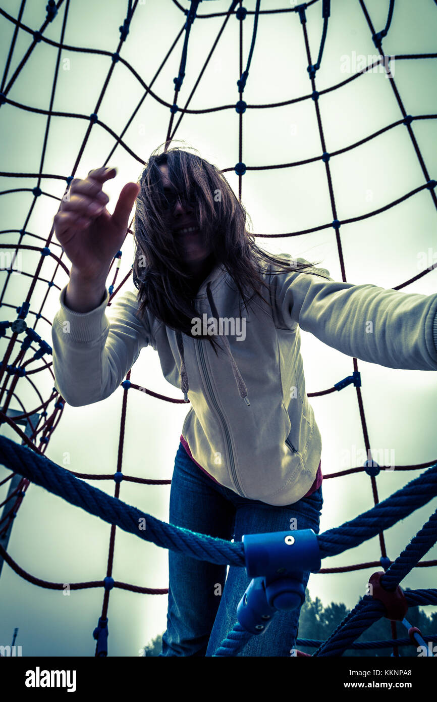 Smiling witch crawling on the net and reaching you out Stock Photo - Alamy